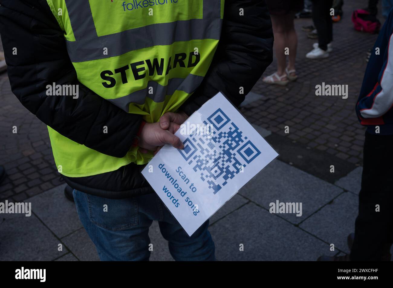Official steward with QR code for hymn words on Good Friday Stock Photo ...