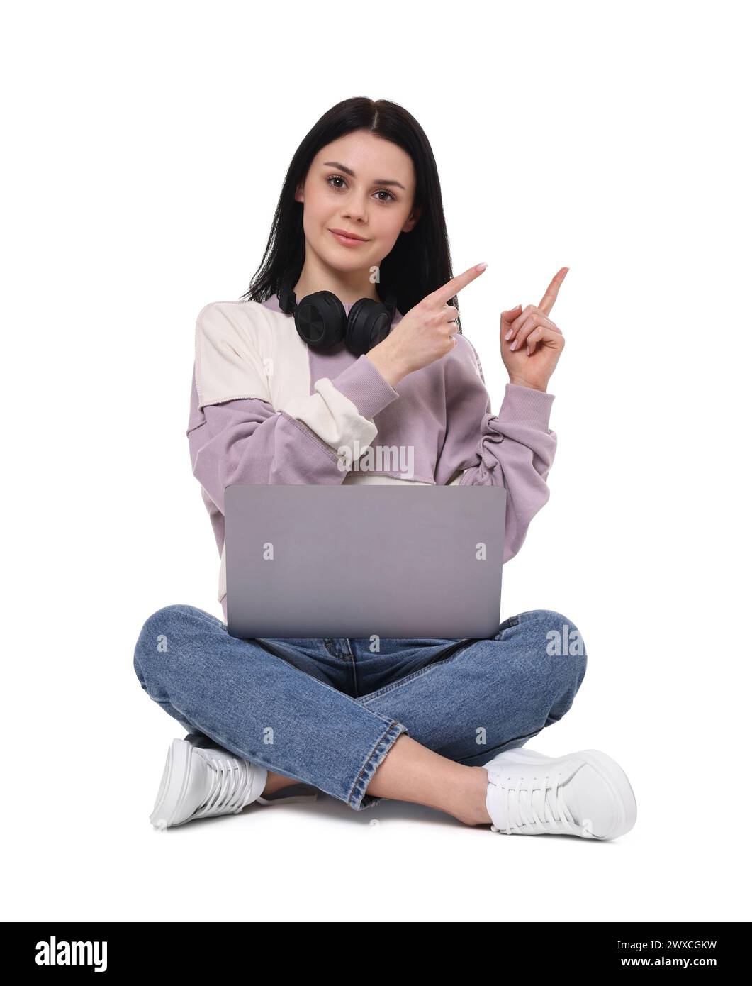 Student with laptop pointing at something on white background Stock ...