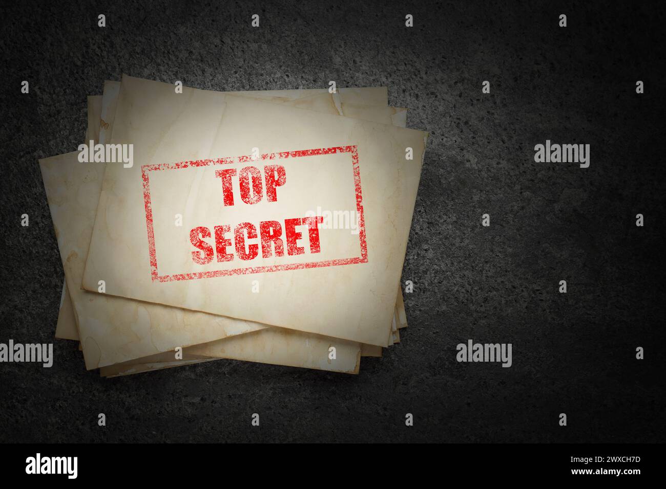 Top Secret stamp. Stacked old letters on grey table, top view. Space ...