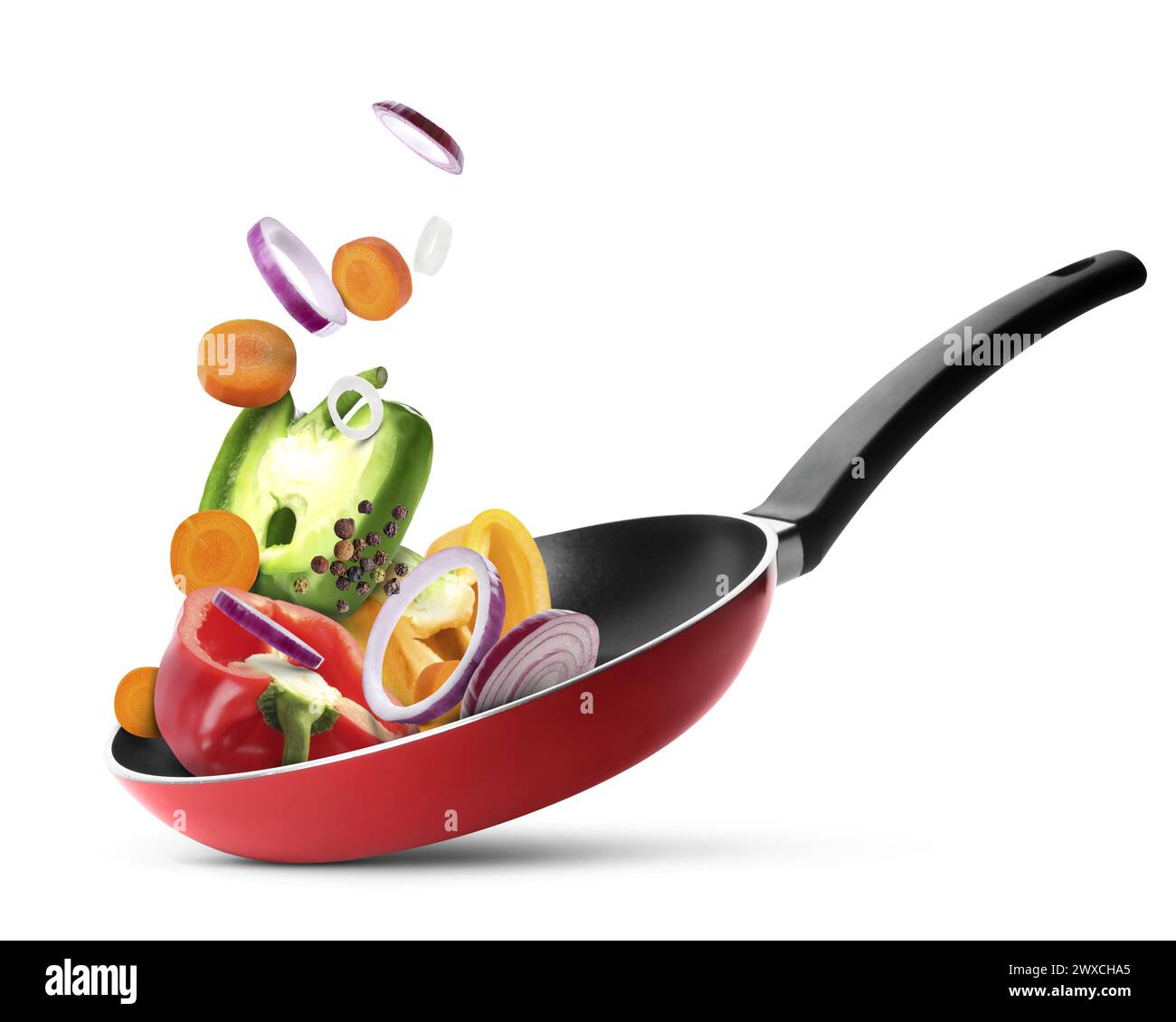 Frying pan with fresh ingredients in air on white background Stock ...