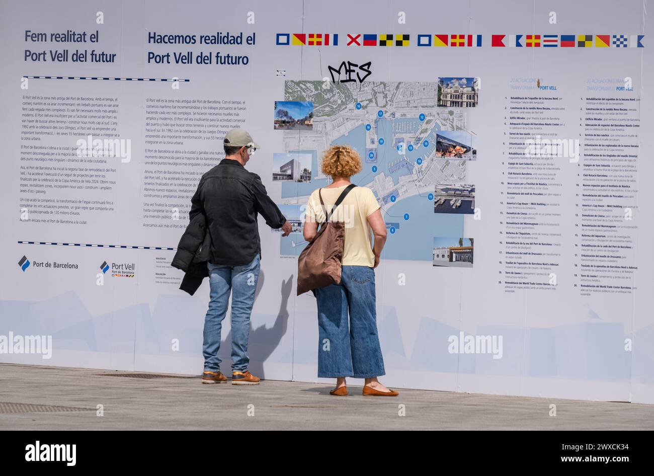 A couple is seen looking at the panel that contains public information ...