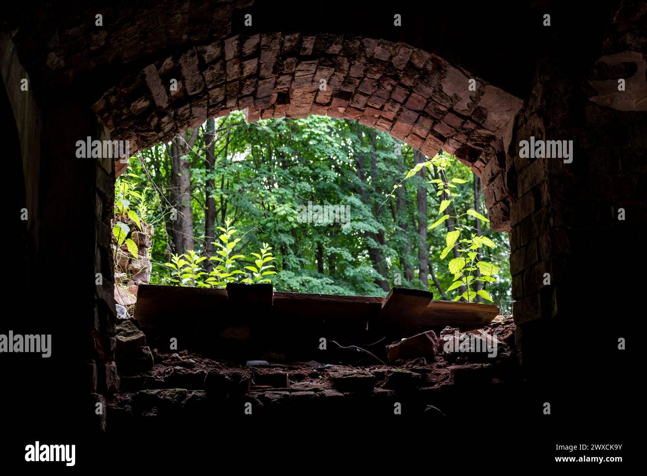 View from the dark basement, window out. Abandoned old house. Manor ...