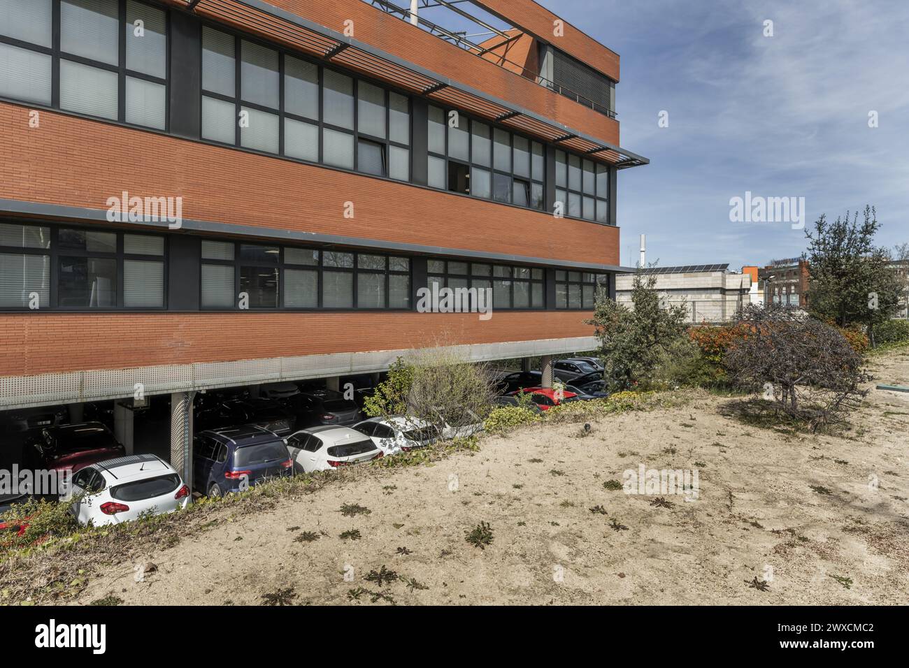 Facade of a brown brick and black metal multi-story office building ...