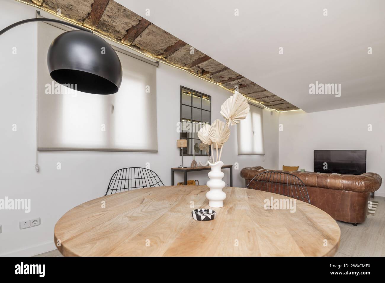 Living room with Chester model sofa bed upholstered in brown leather ...