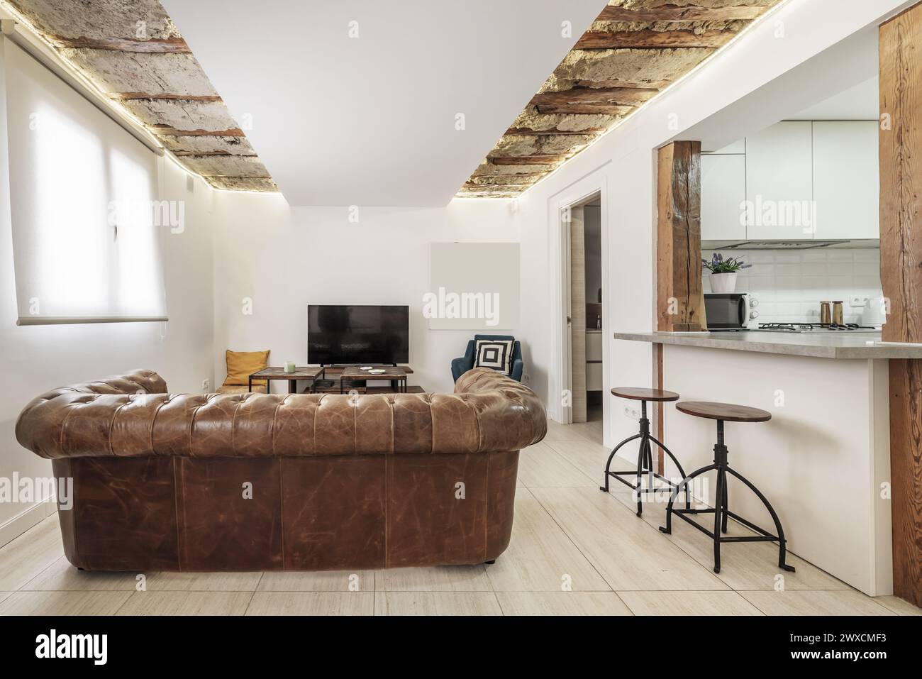 Living room with Chester model sofa bed upholstered in brown leather ...