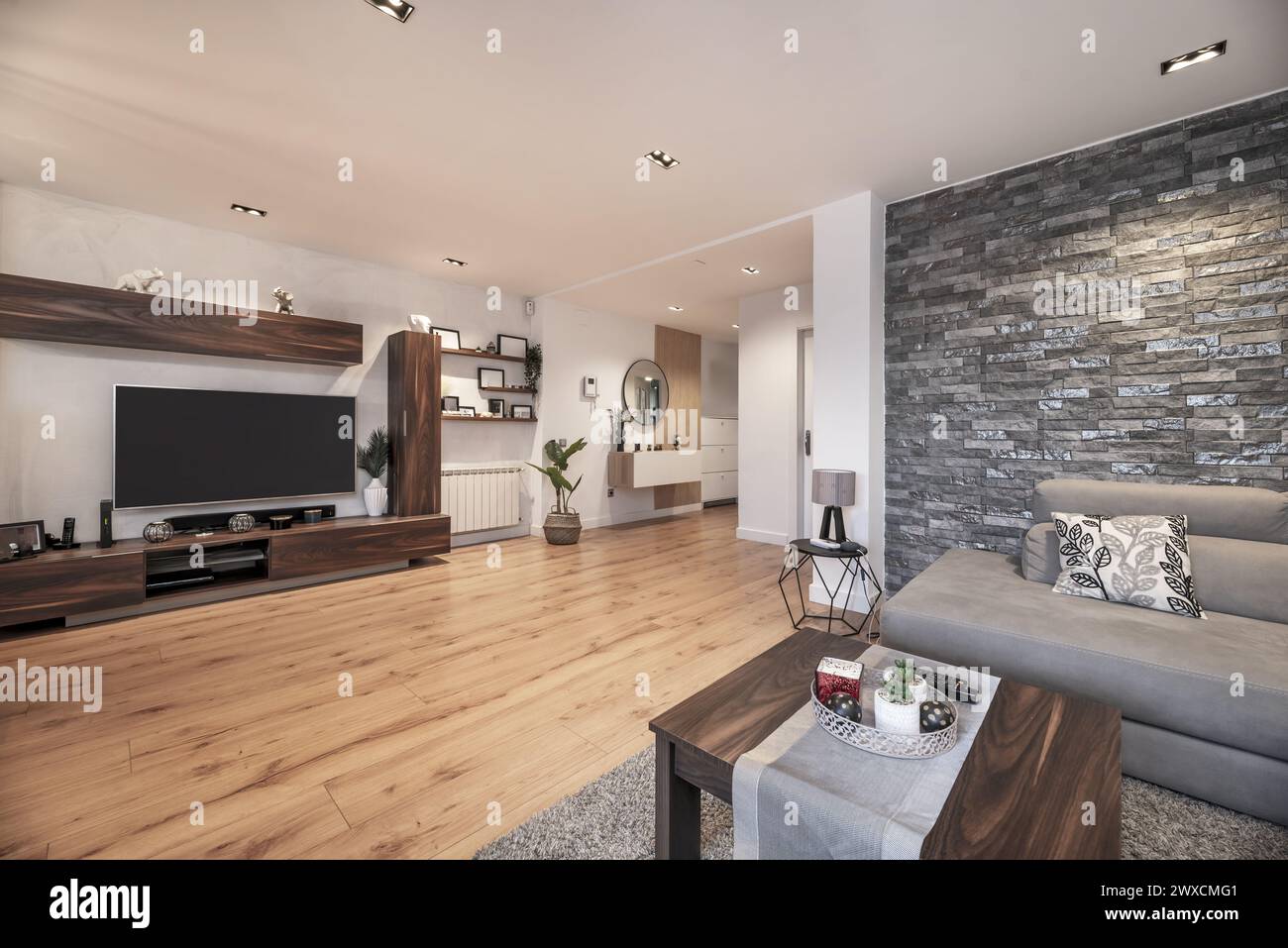 Living room with coffee table and corner sofa upholstered in gray ...