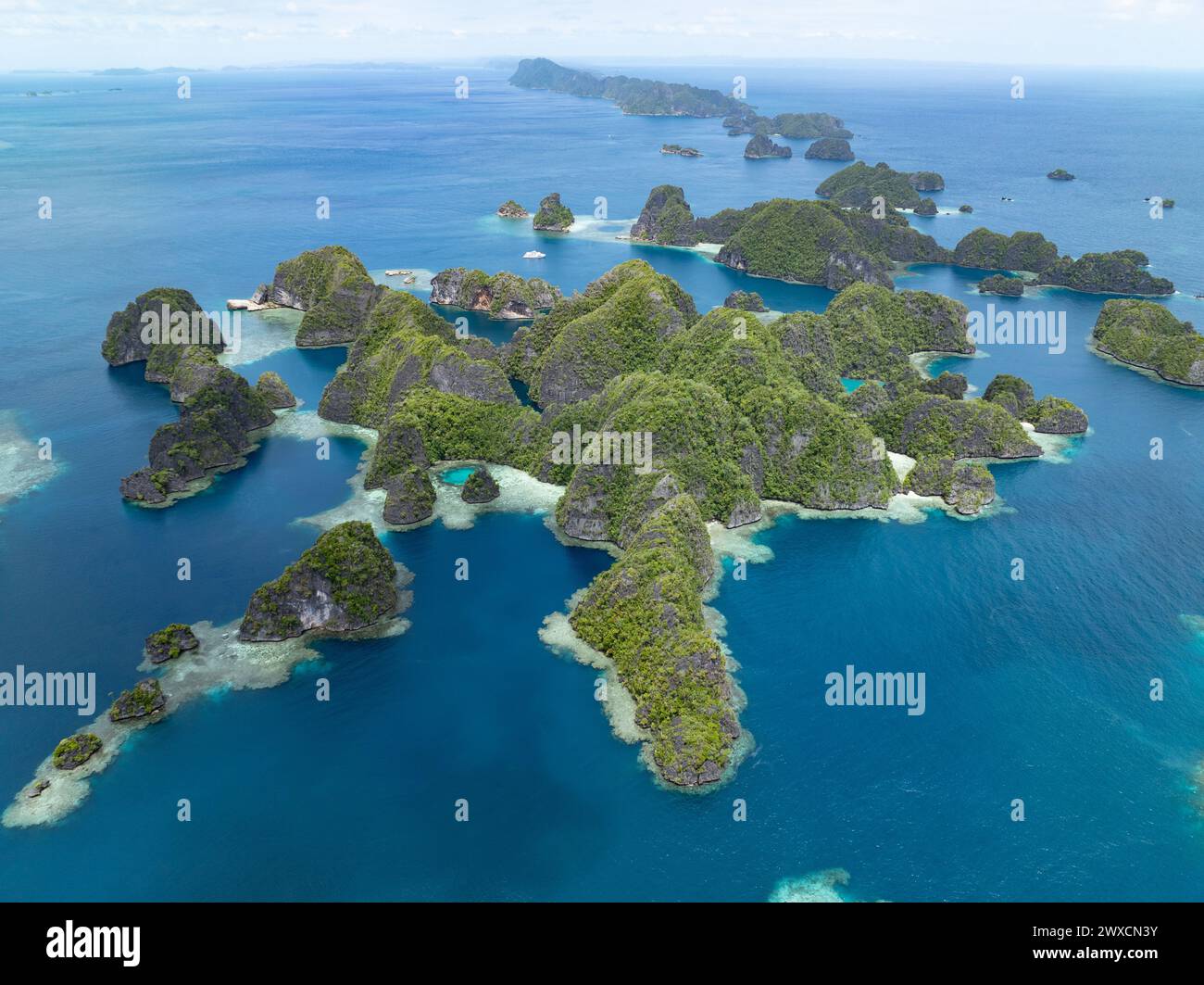 The limestone islands of Balbalol, fringed by reef, rise from Raja ...