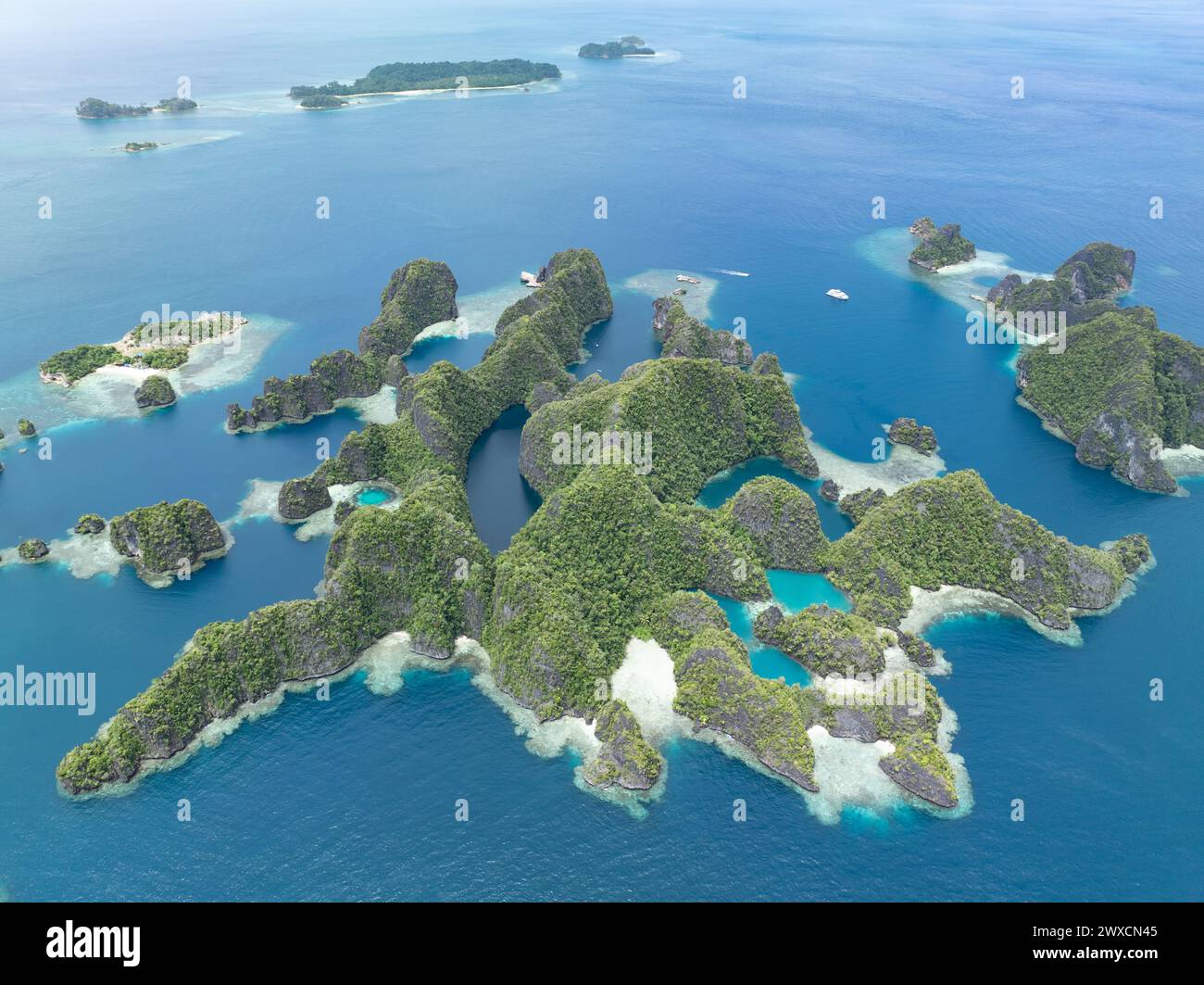 The limestone islands of Balbalol, fringed by reef, rise from Raja ...
