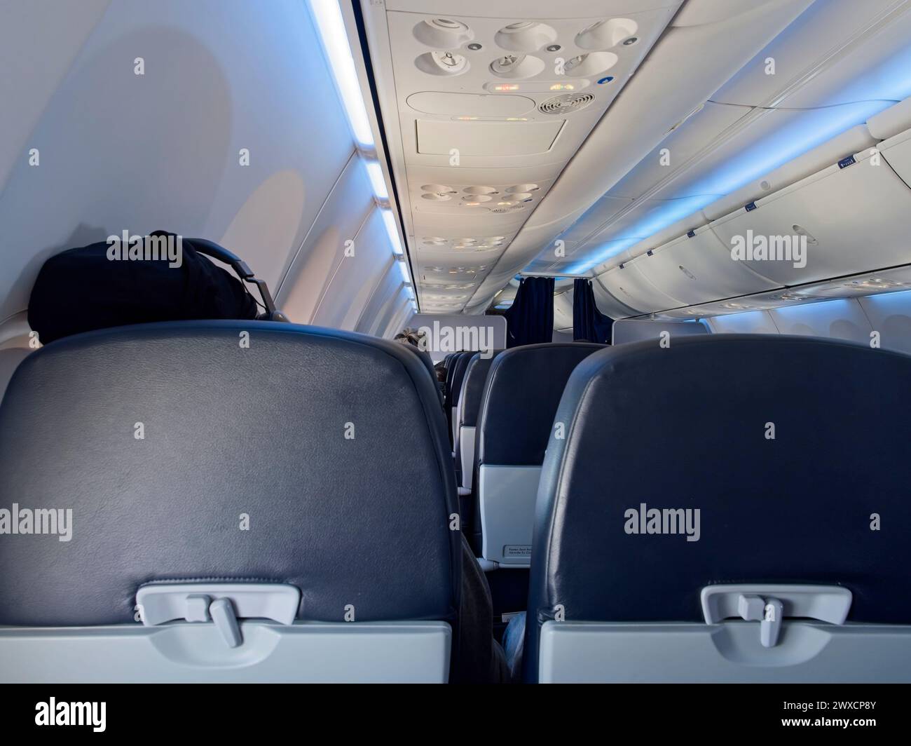 Interior view of an airplane from economy class Stock Photo - Alamy