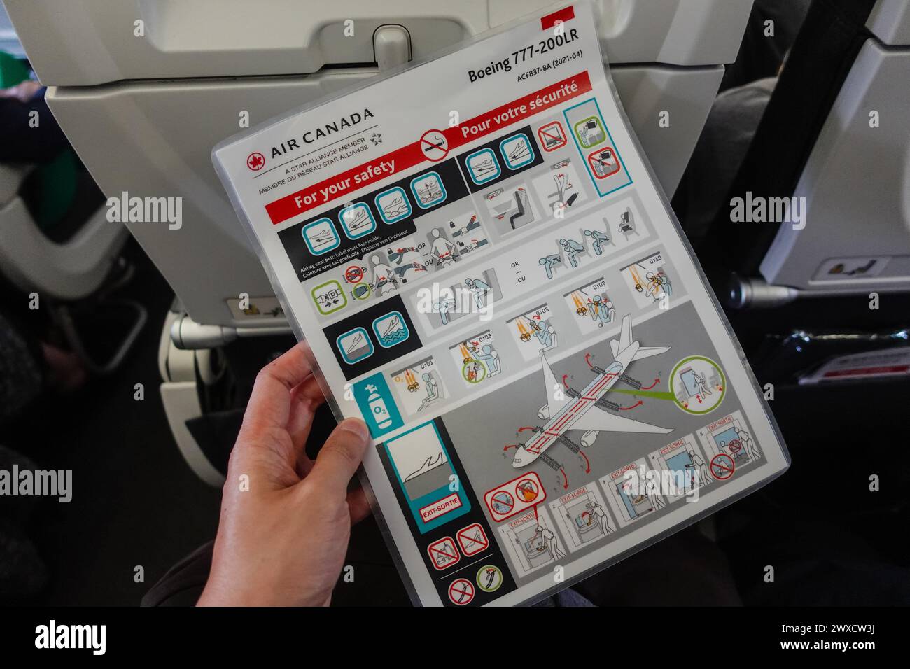airplane safety briefing and instruction card Stock Photo - Alamy