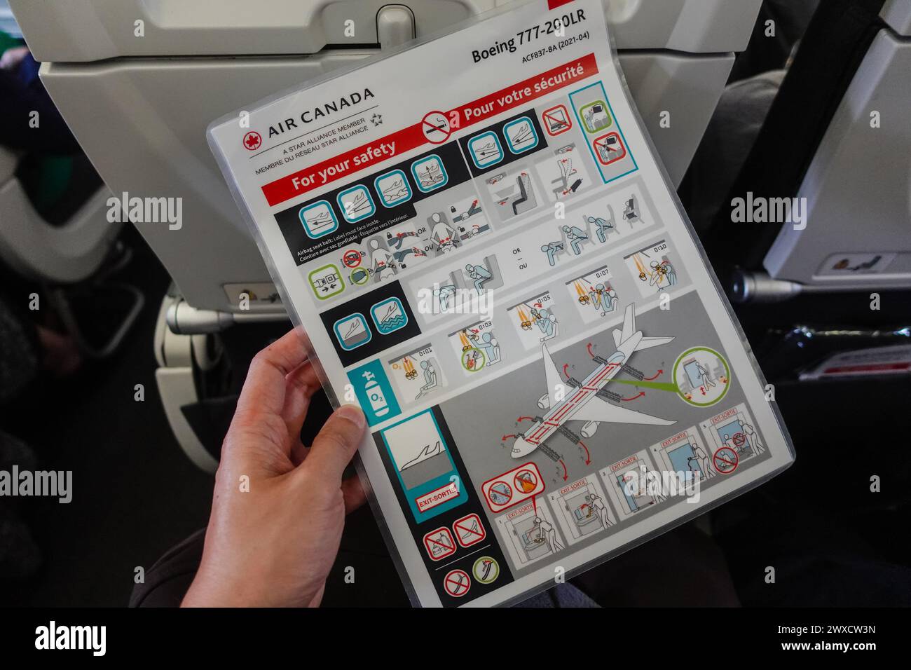 airplane safety briefing and instruction card Stock Photo - Alamy