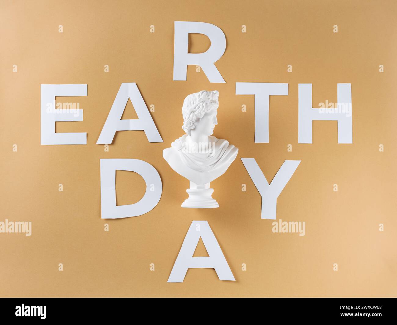 Earth Day Inscription and Antique Plaster Sculpture on Beige Background ...