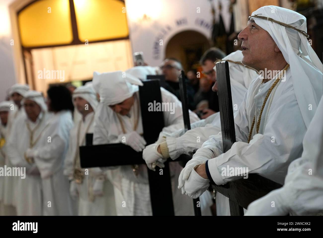 Members of a confraternity pray during a Holy Thursday procession the ...