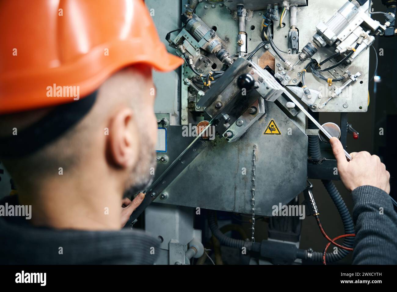 Worker cuts spacer frames in a window production Stock Photo - Alamy