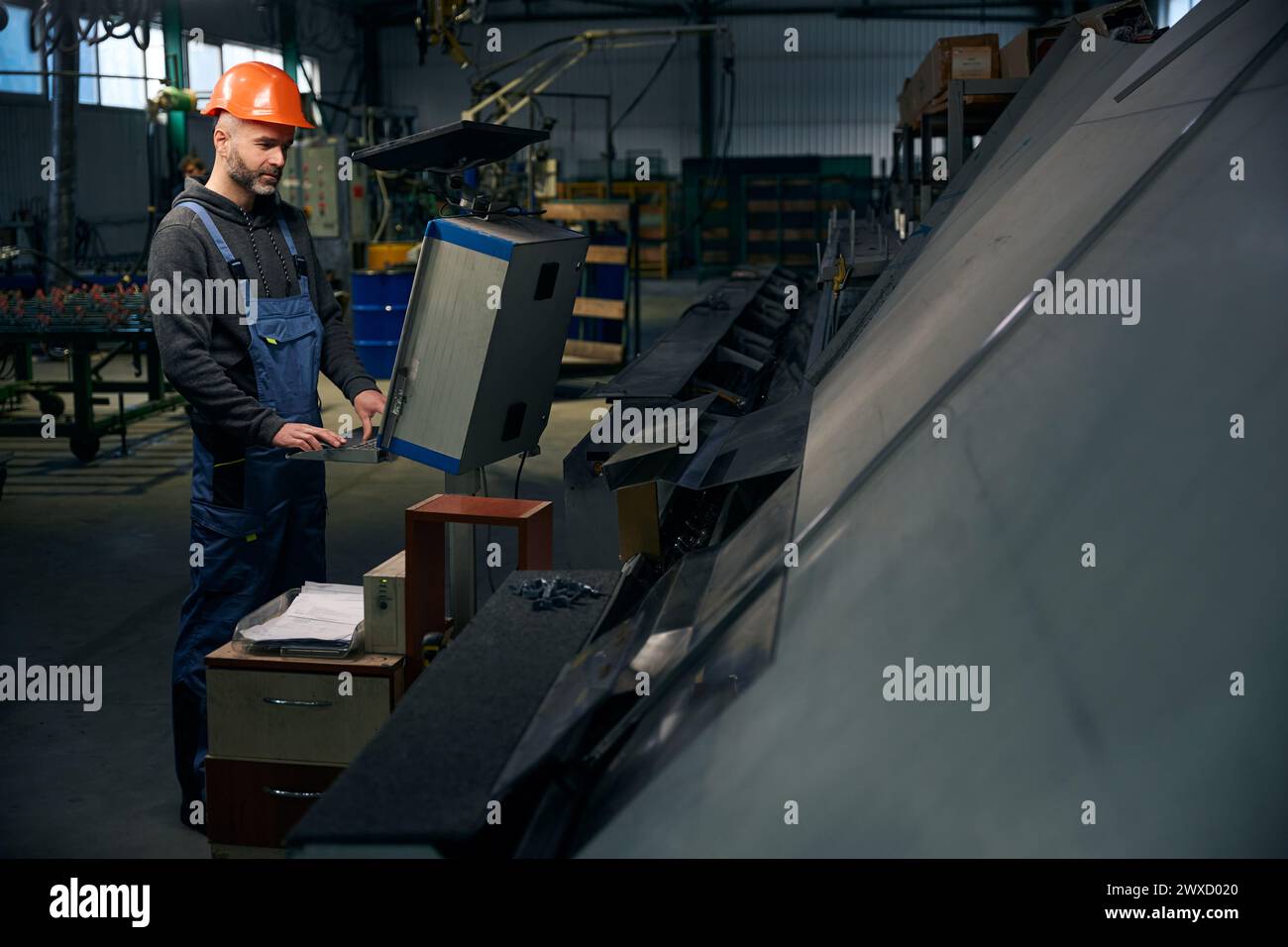 Employee at a window production facility uses high-tech equipment Stock ...