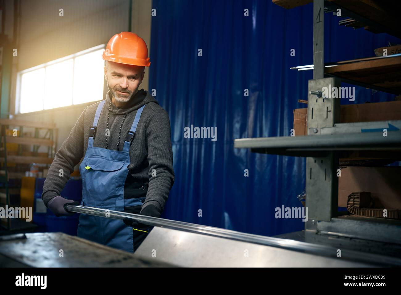 Worker uses modern equipment in a window production Stock Photo - Alamy