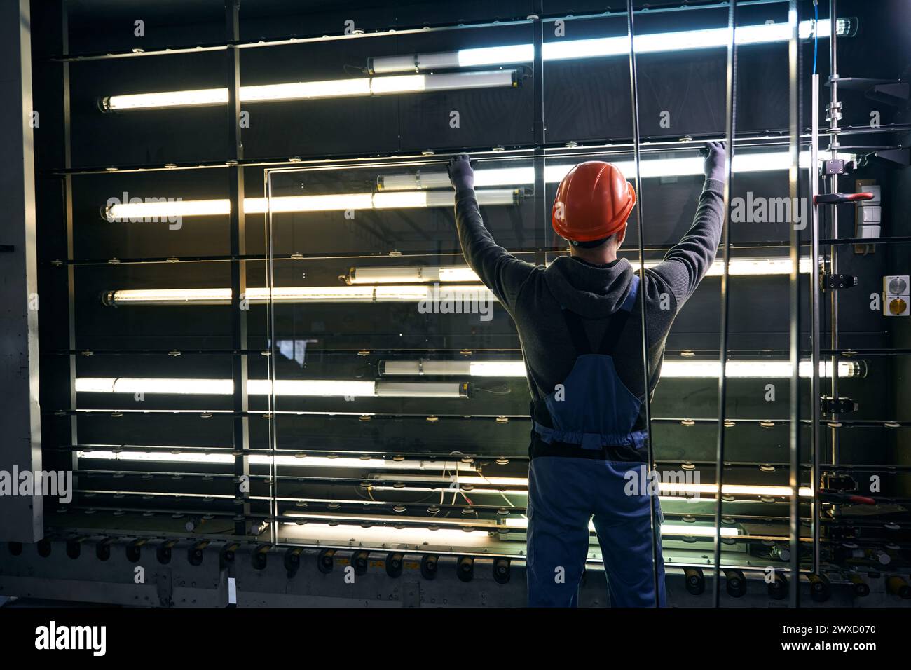 Master performs pressing of a double-glazed window in window production ...