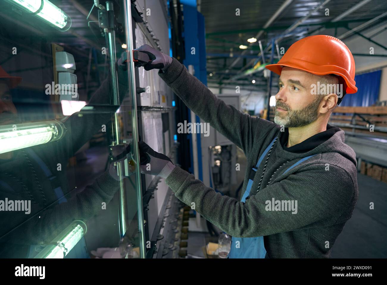 Master performs the initial sealing of a spacer frame Stock Photo - Alamy