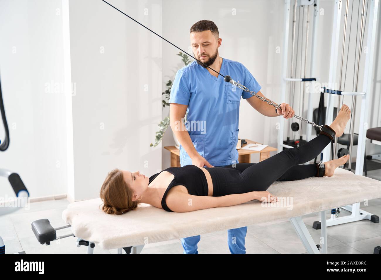 Spinal traction procedure on a special simulator Stock Photo - Alamy