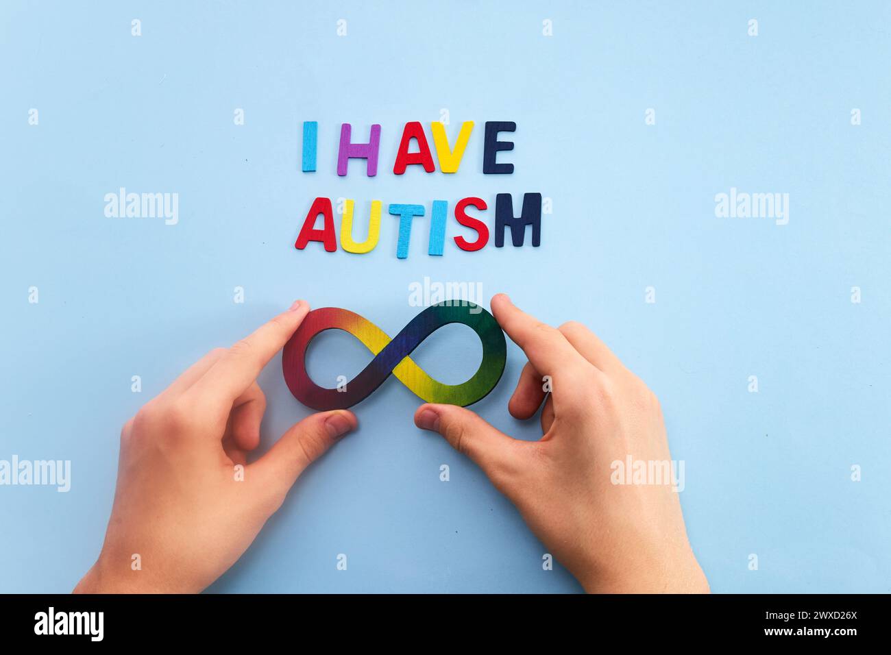 Autistic boy hands and rainbow eight infinity symbol. Autism awareness ...