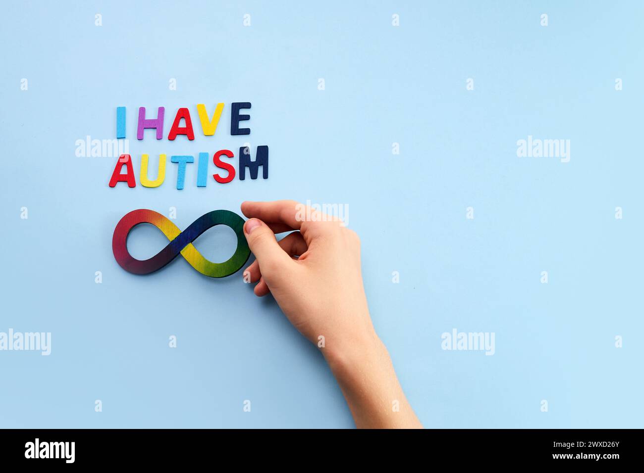 Autistic boy hands and rainbow eight infinity symbol. Autism awareness ...