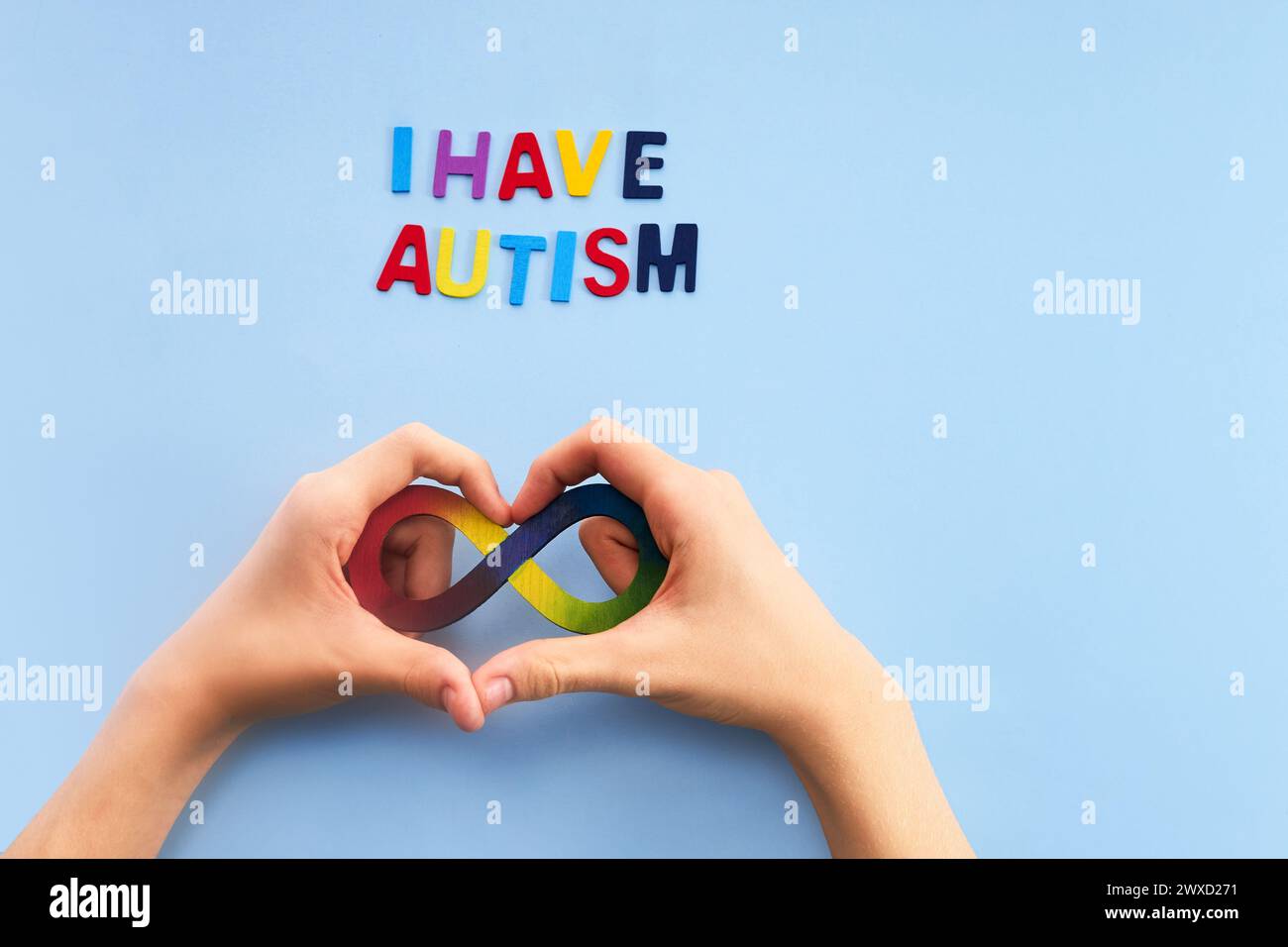 Autistic boy hands and rainbow eight infinity symbol. Autism awareness ...