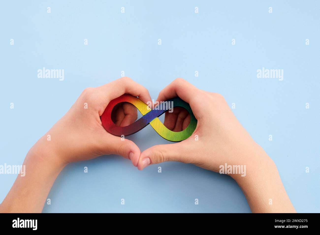 Autistic boy hands and rainbow eight infinity symbol. Autism awareness ...