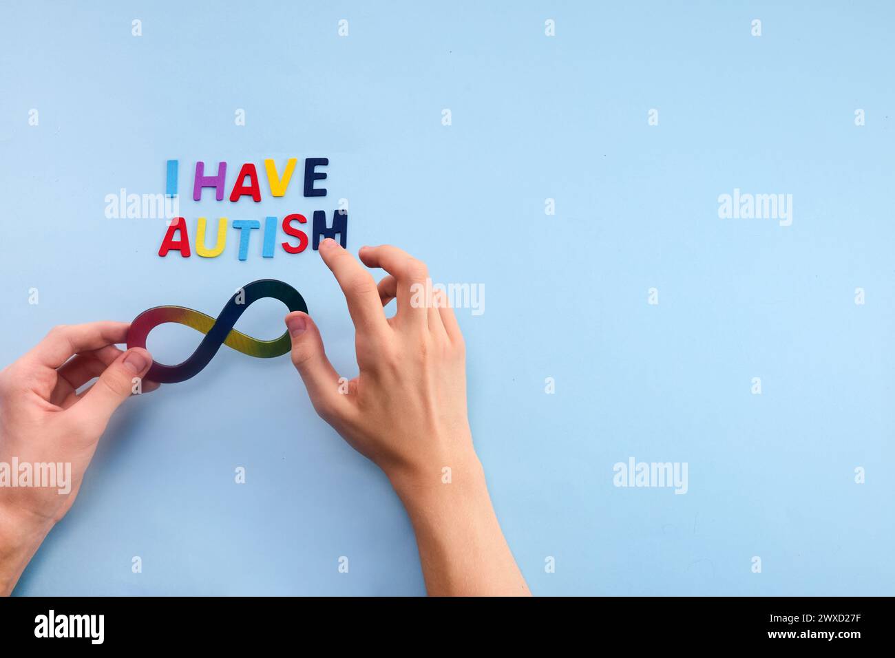 Autistic boy hands and rainbow eight infinity symbol. Autism awareness ...