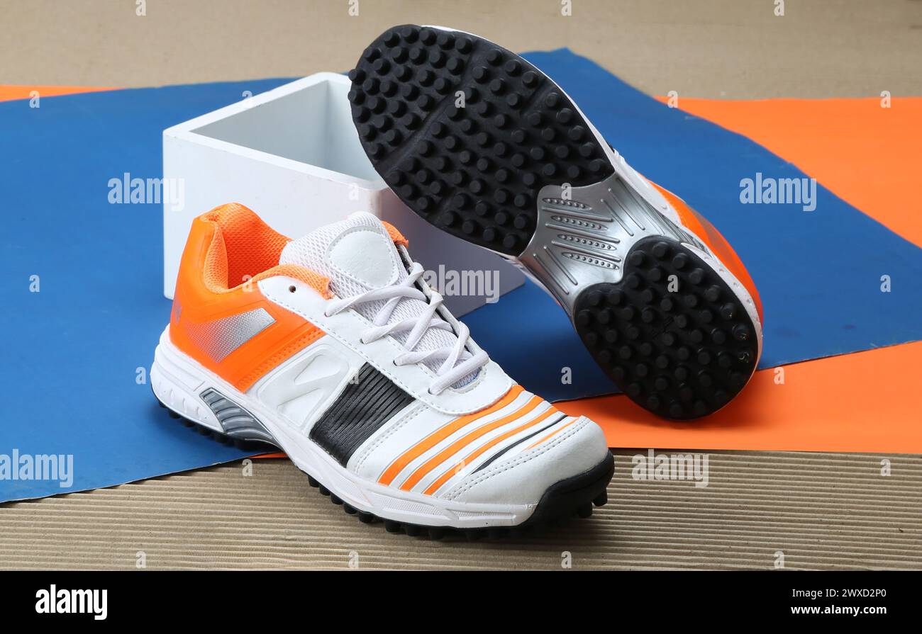 Cricket shoes pair creative banner shoot Stock Photo - Alamy