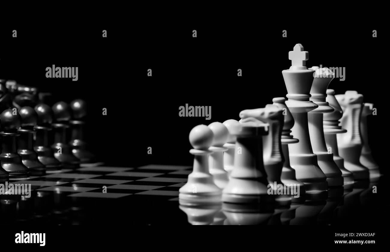 Close up of Chess pieces on a reflective mirror board surface with a ...