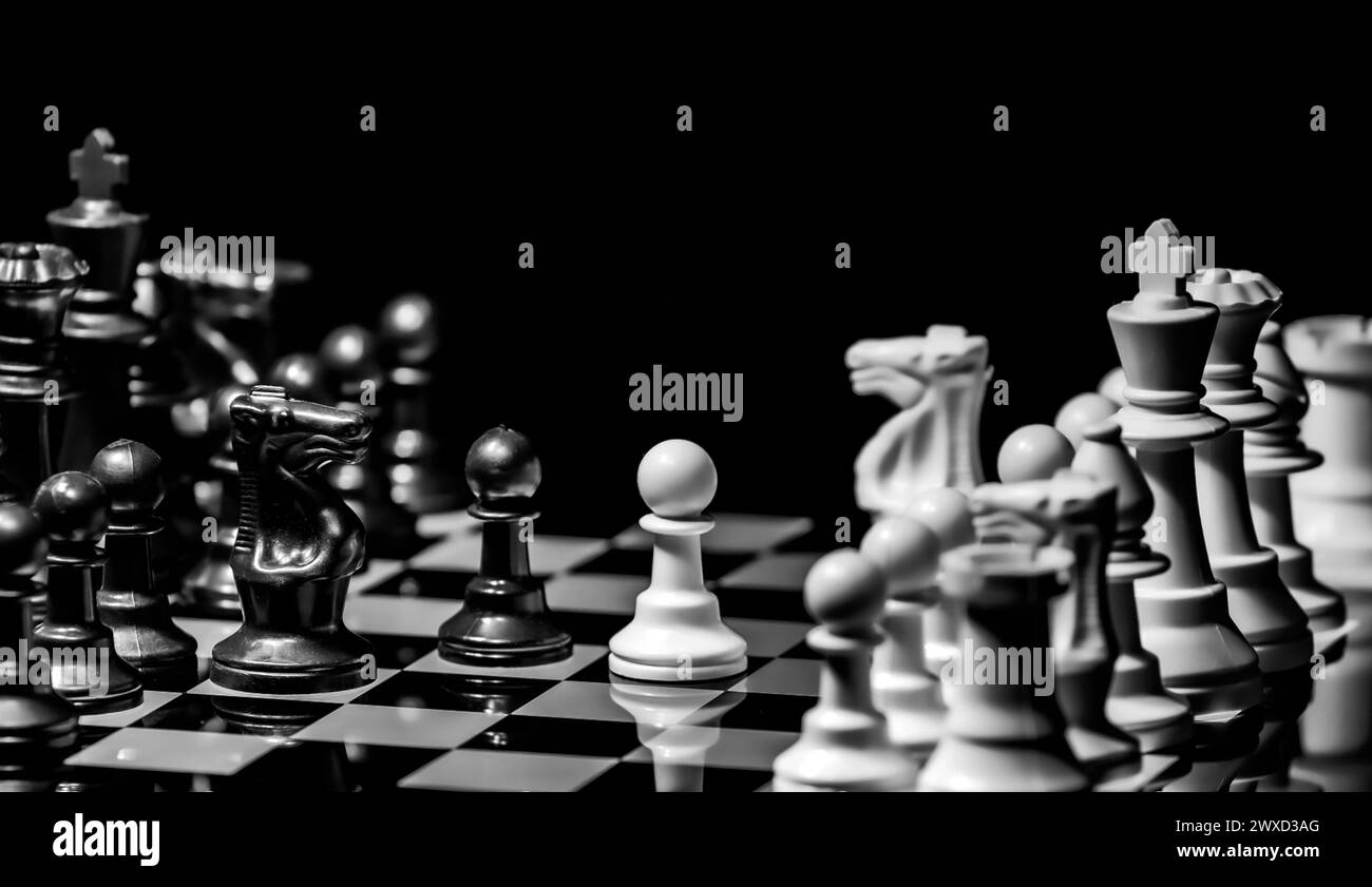 Close up of Chess pieces on a reflective mirror board surface with a ...