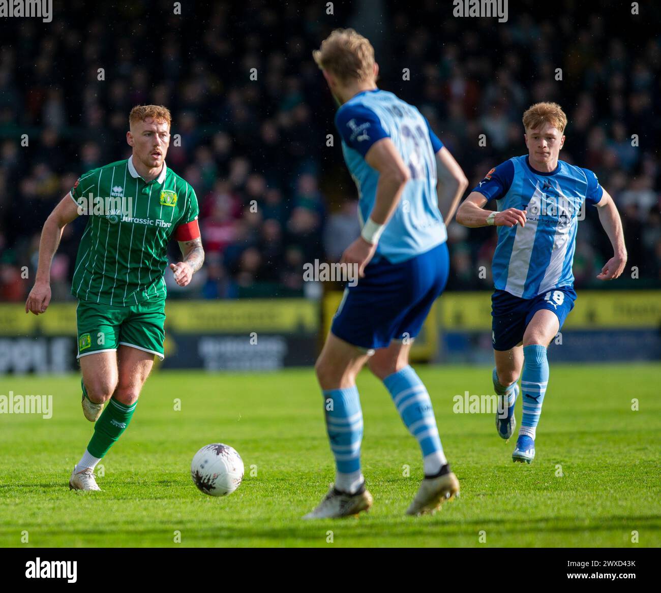 Matty Worthington of Yeovil Town runs with the ball at Dean Moxey of ...