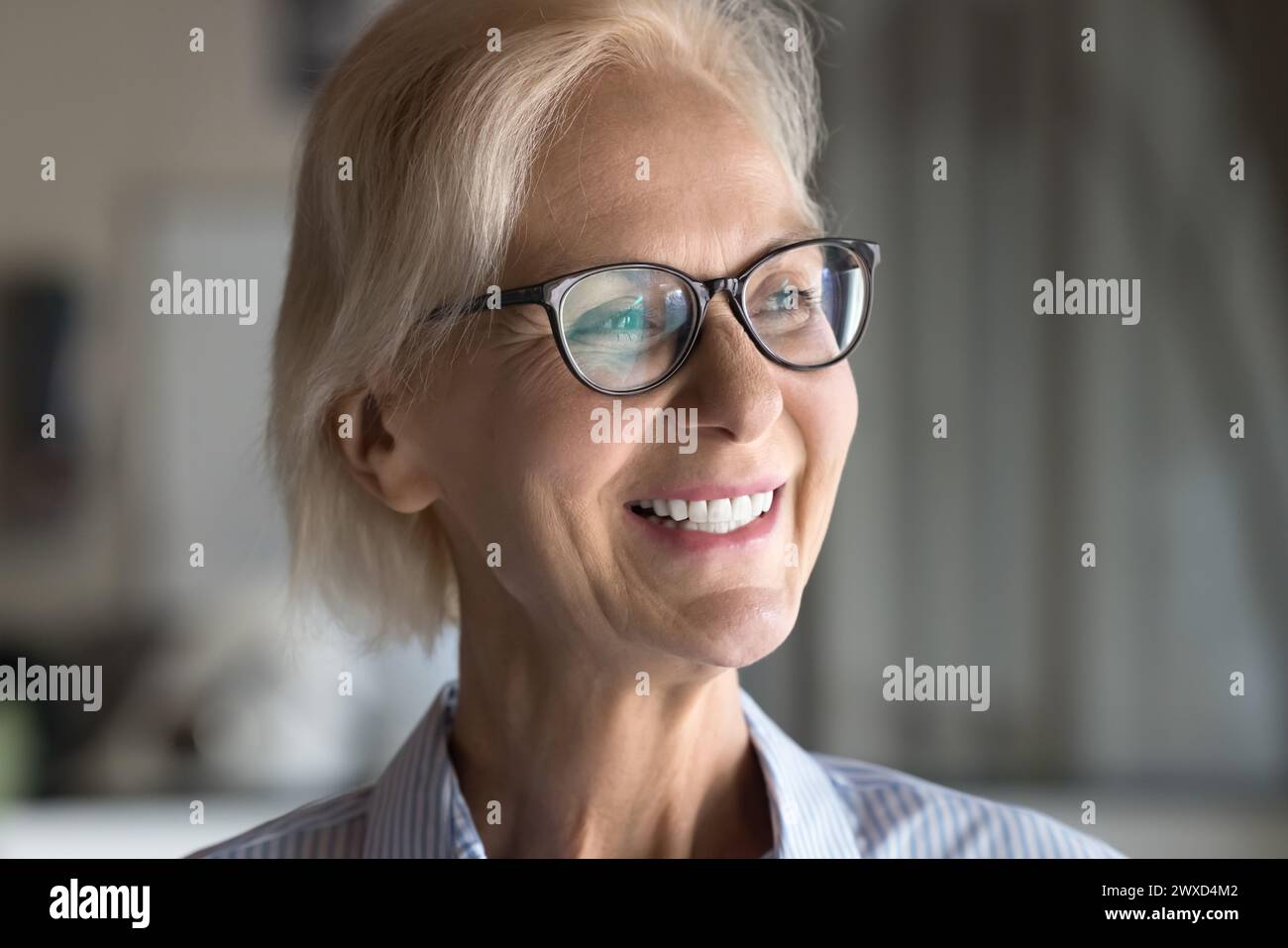 Cheerful dreamy blonde elder professional woman close up portrait Stock Photo - Alamy