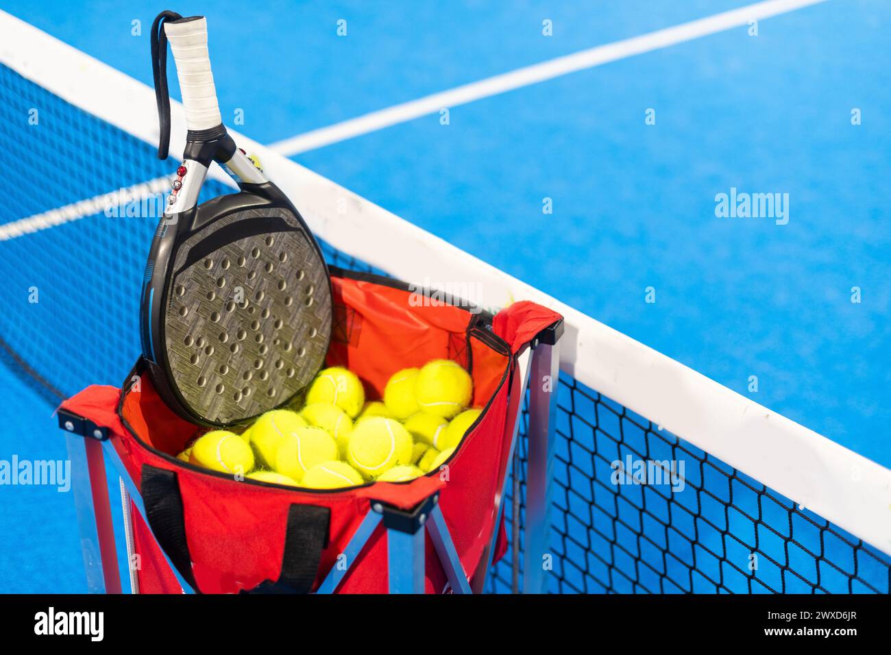 Paddle tennis rackets, balls and basket in court still life Stock Photo ...