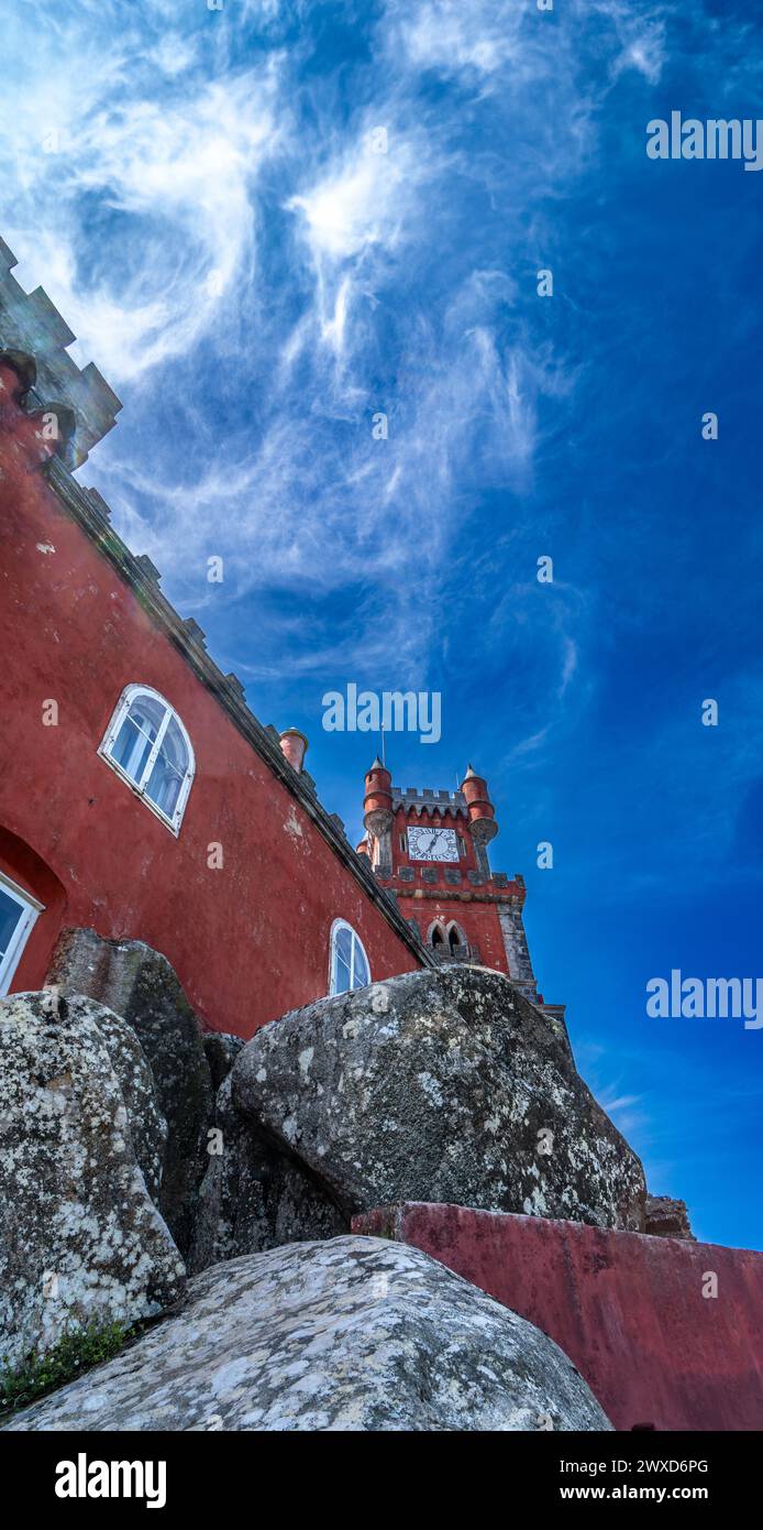 Low angle view of part of a red wall of the Pena Palace on some large ...