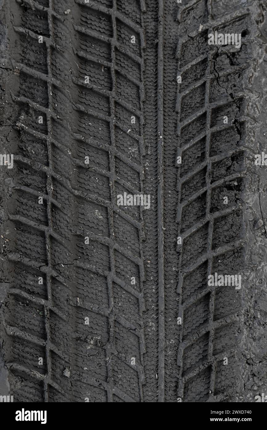Traces of car tire tread in the ground. Pattern. Dark abstract ...