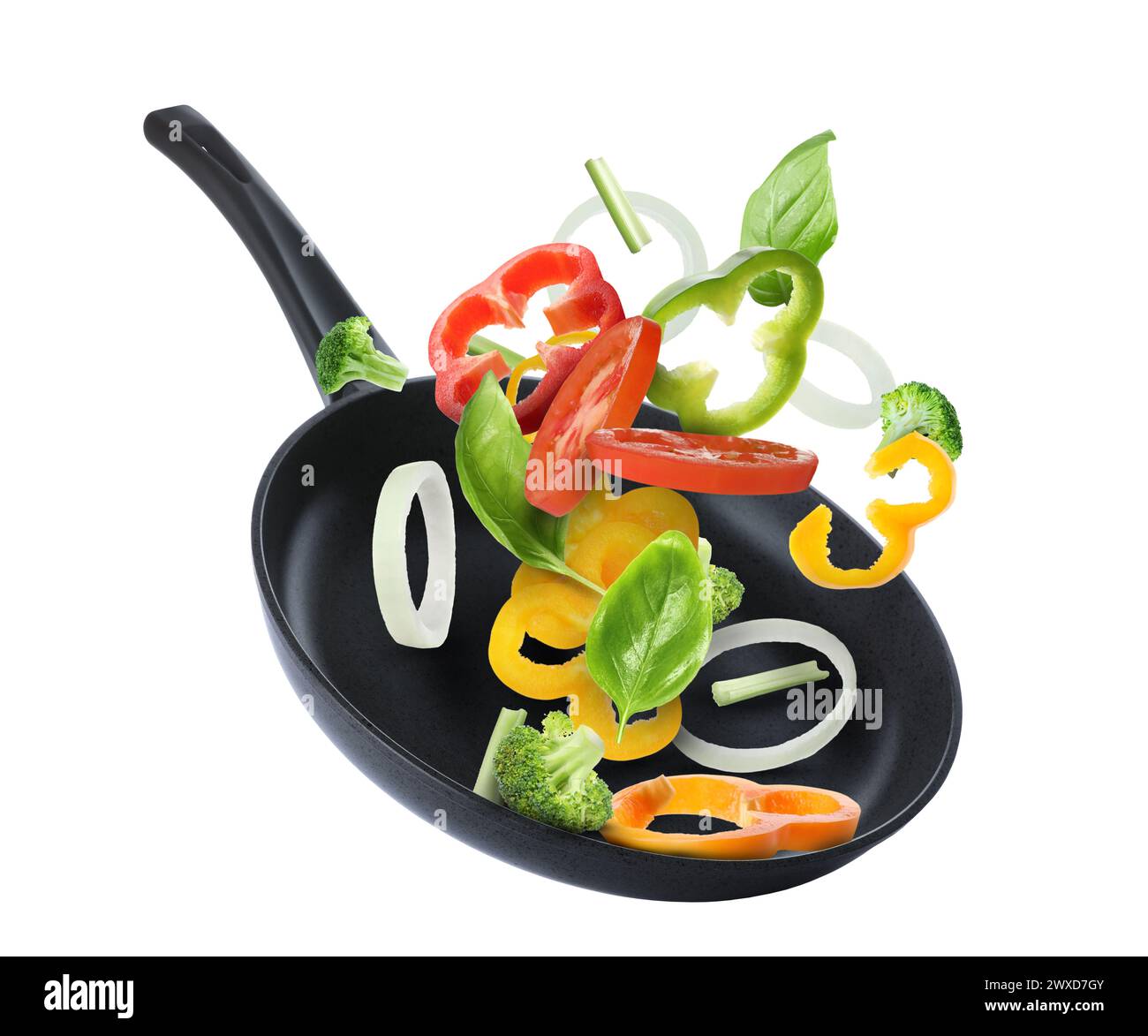 Frying pan with fresh ingredients in air on white background Stock ...