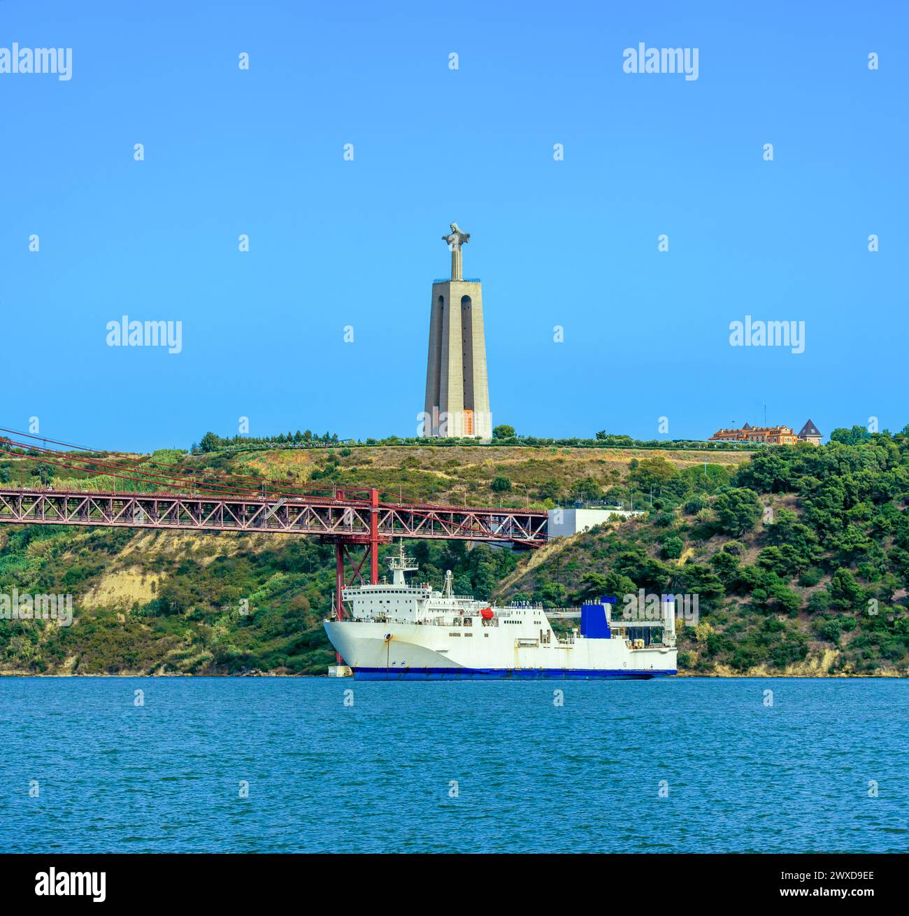 White ferry sailing under Lisbon's 25 de Abril steel suspension bridge ...