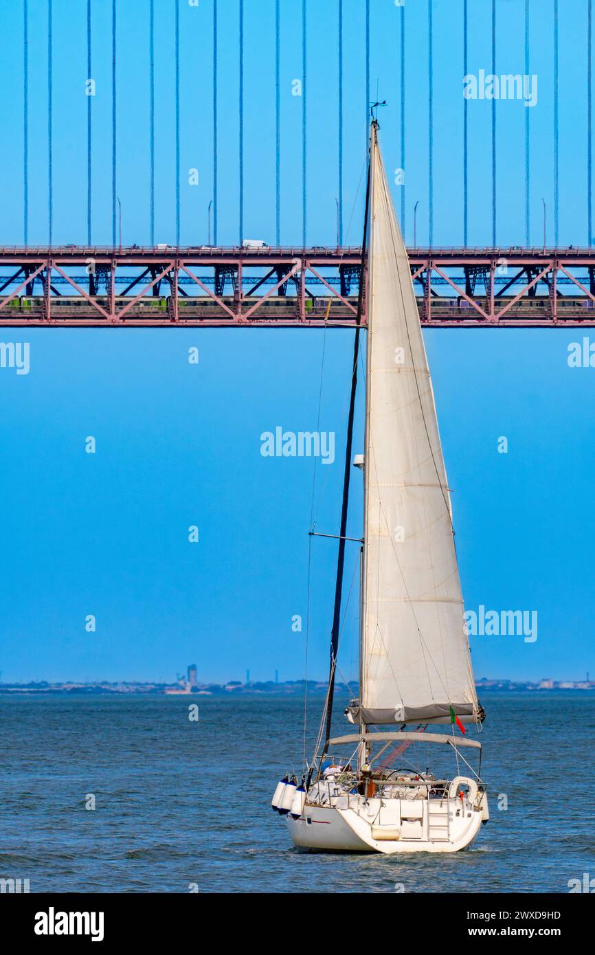 Tourist sleeping on top of a sailboat navigating the Tagus River with ...