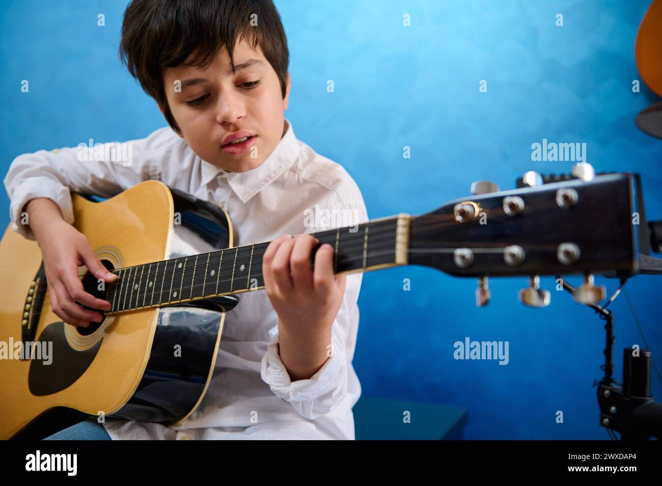 Teenage boy pianist musician plucking the strings while playing the ...