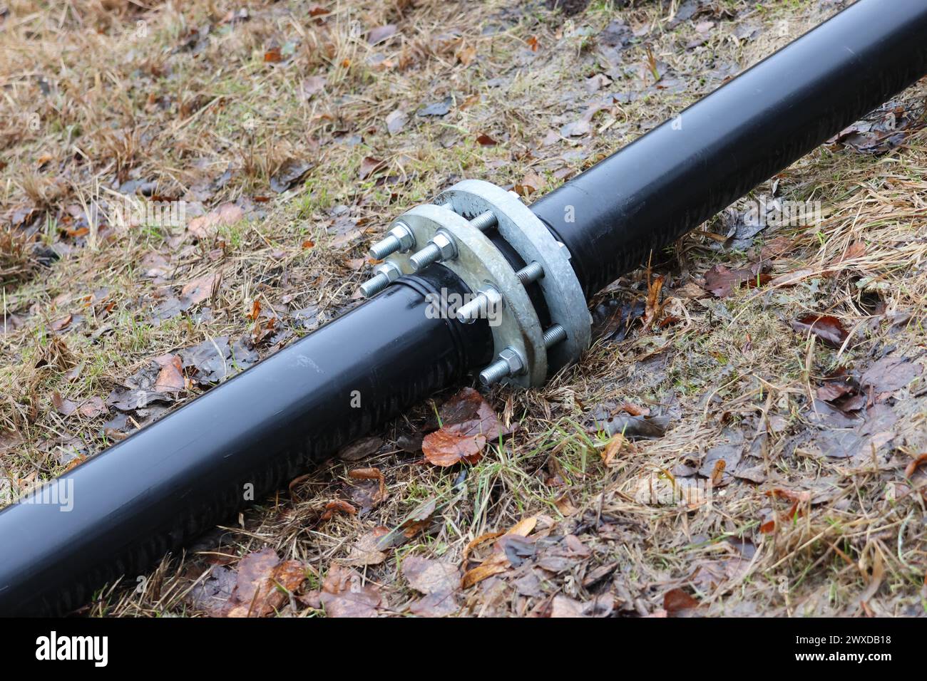 Clear bolts and screws. The pipes are located on the ground in nature ...