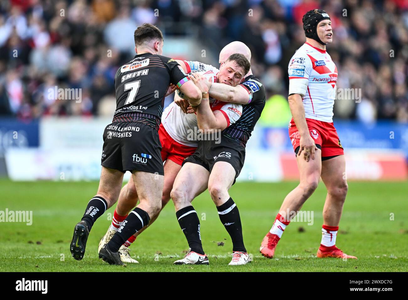 Morgan Knowles of St. Helens is tackled by Liam Marshall of Wigan ...