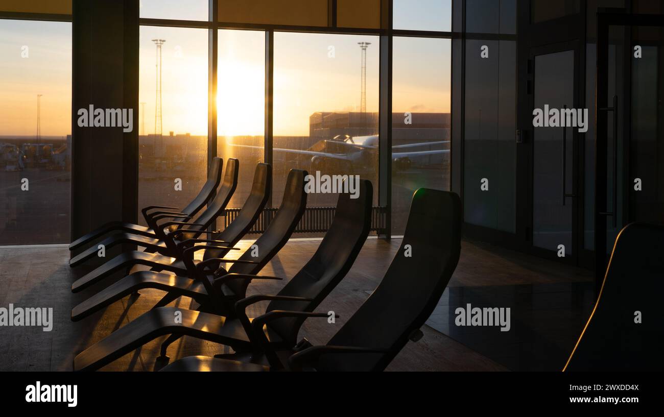 Airport waiting room with a bay window at sunrise Stock Photo - Alamy