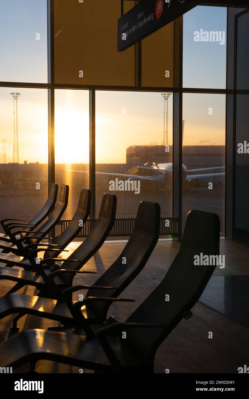 Airport waiting room with a bay window at sunset Stock Photo - Alamy