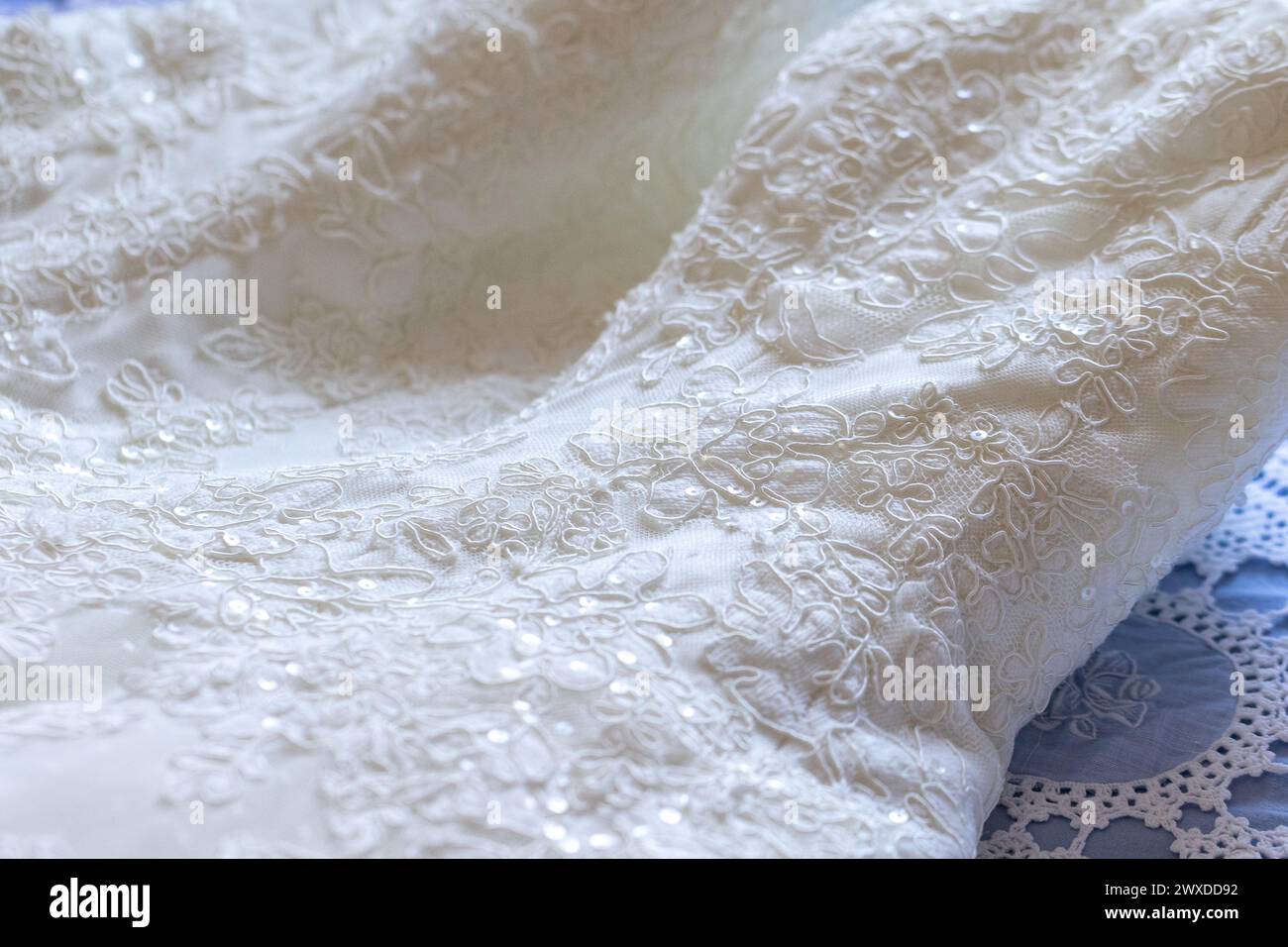 close-up of an elaborate lace pattern on a bridal gown, highlighting ...