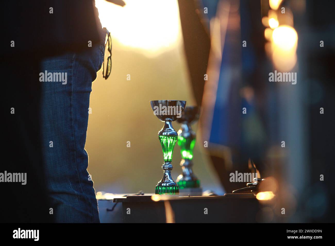 The sun sets casting a warm glow on a trophy, highlighting the moment ...