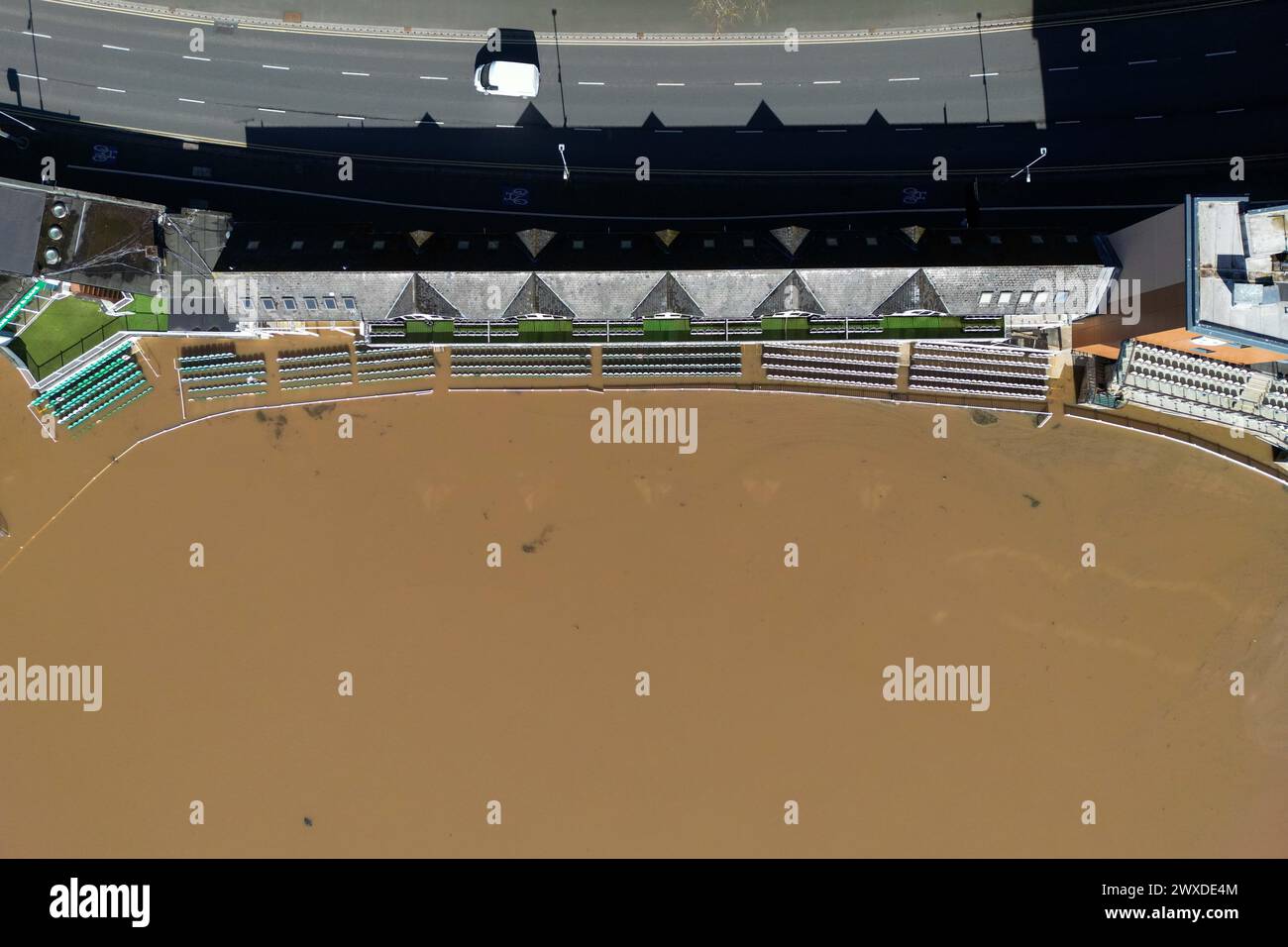 An aerial view shows a vehicle passing a flooded New Road Cricket Club ...