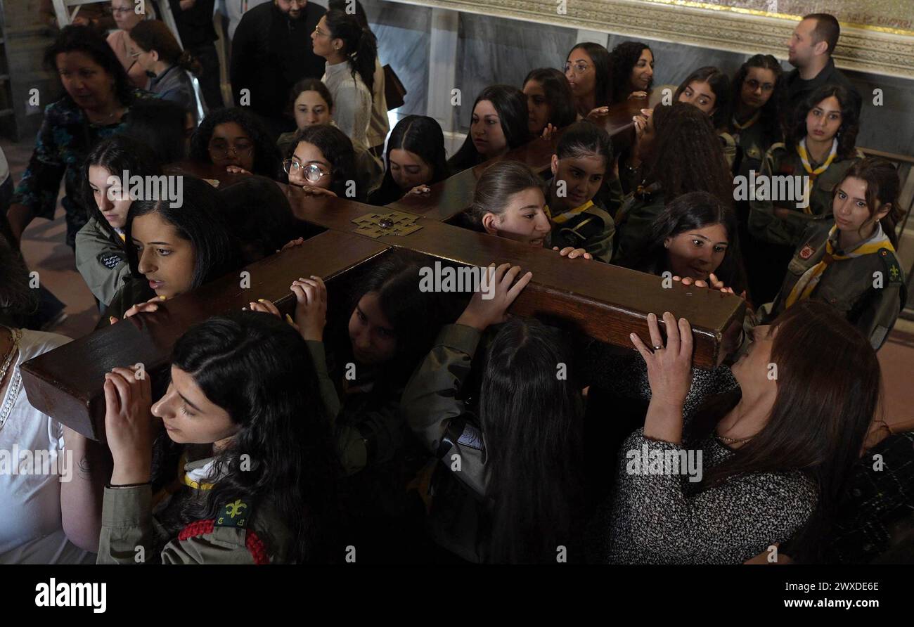 Christian Arab scouts carry a large wooden cross inside the Church of ...