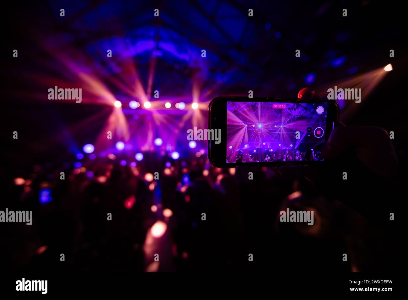 Hands holding phone and making photos on the concert. Concert ...