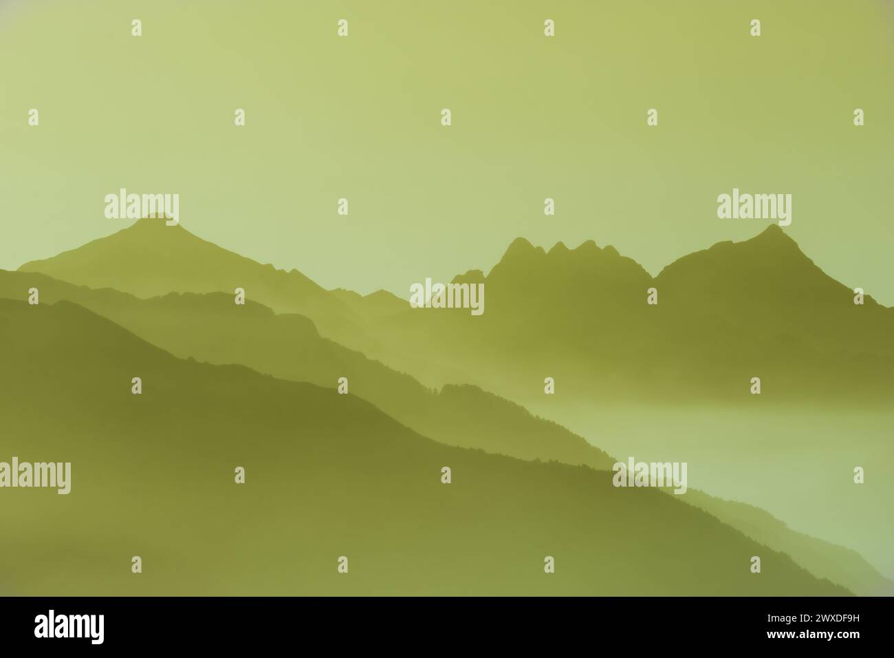 Spectacular mountain ranges silhouettes in shades of yellow Stock Photo ...